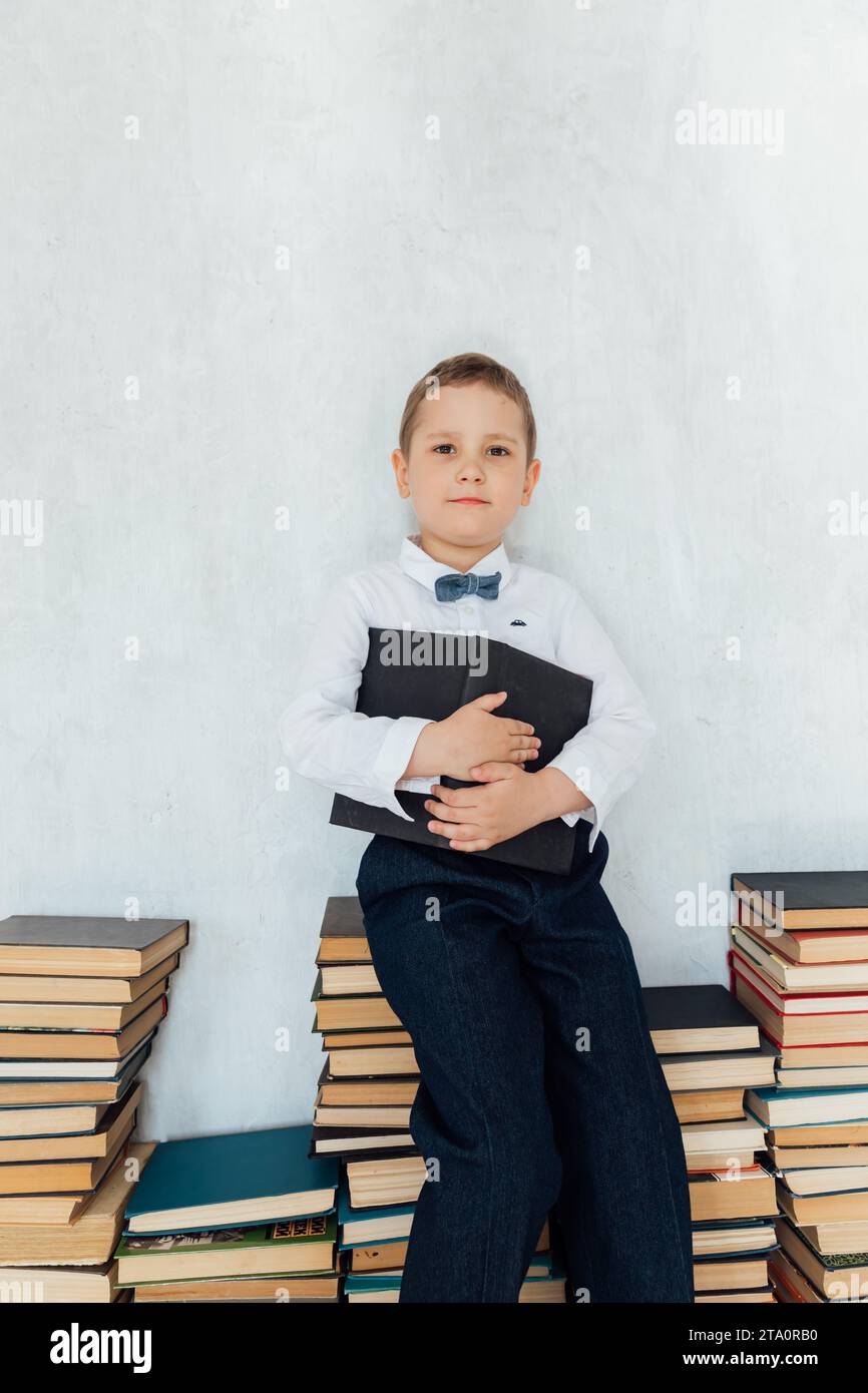Little boy loves to read stacks of books Stock Photo - Alamy