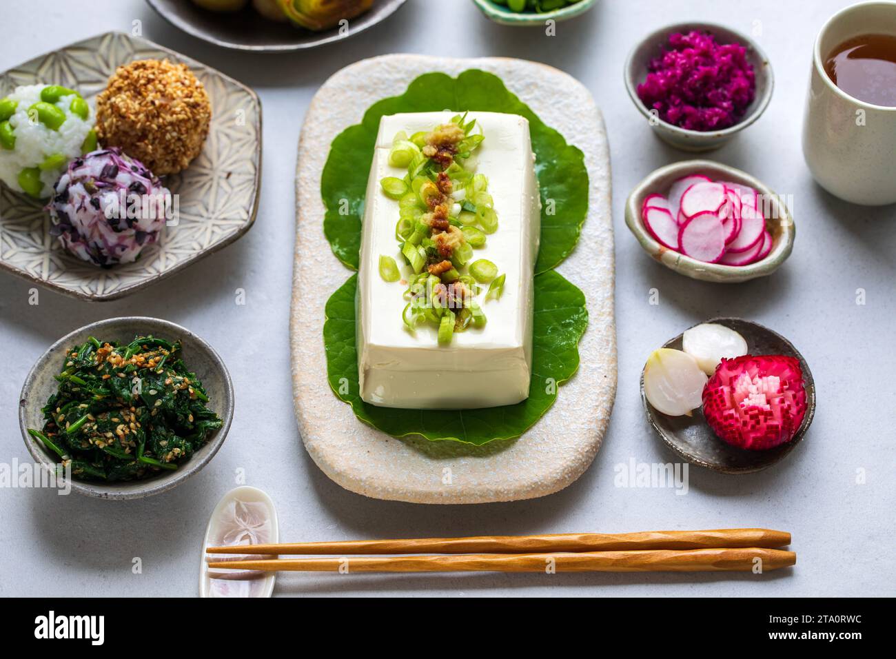 Japanese lunch with silken tofu, onigiri, spinach gomae, miso leeks ad ...