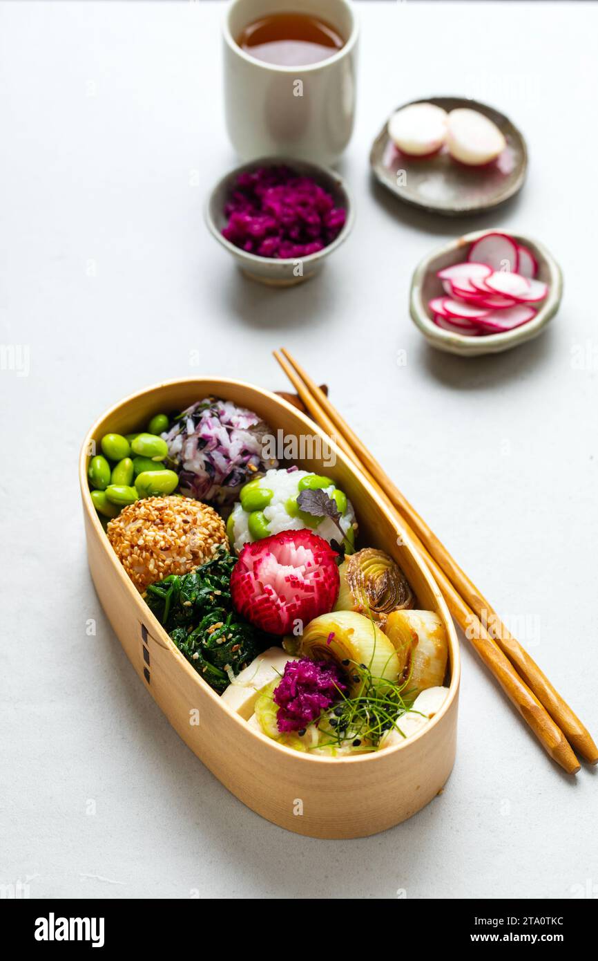 Japanese lunch with silken tofu, onigiri, spinach gomae, miso leeks ad ...