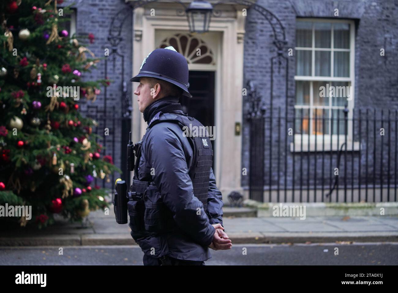 London UK. 28 November 2023. .A police officer walks past the decorated ...