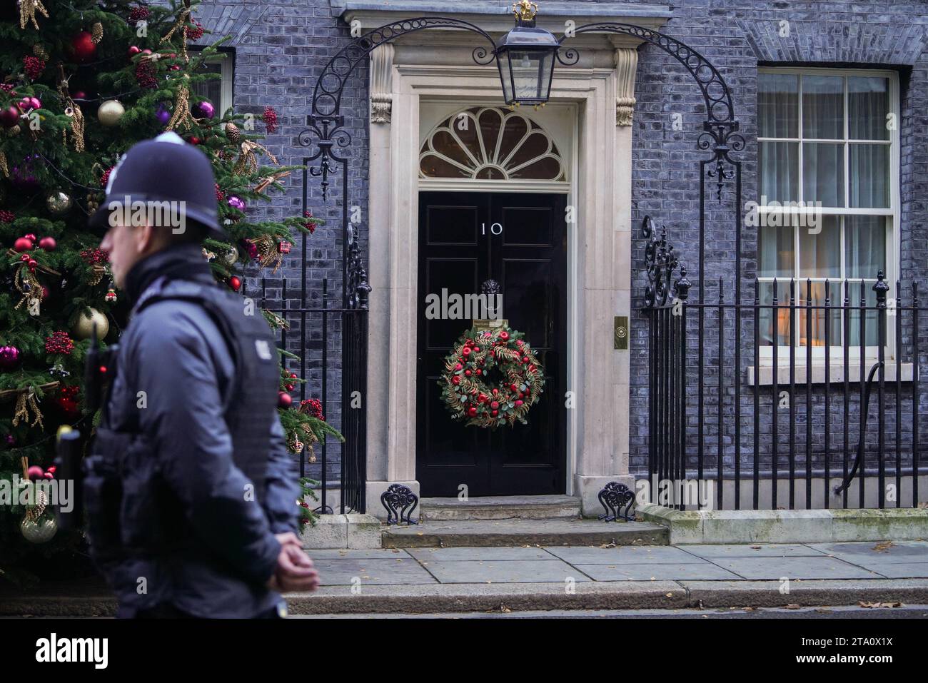 London UK. 28 November 2023. .A police officer walks past the decorated ...