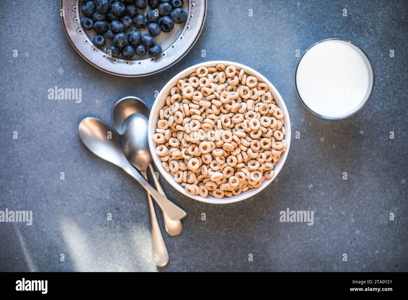 Variety of breakfast whole grain cereals and muesli in bowls on a light ...