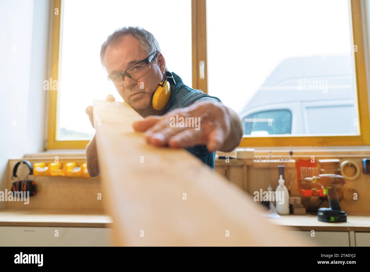 Diligent Carpenter checking his wood work for faults. Repair and job ...