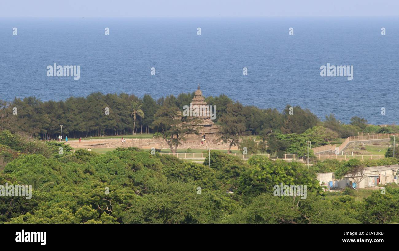 Sea Shore temple in beach background surrounded with trees and bushes ...