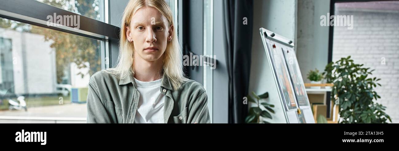 appealing non binary person with long hair in business casual attire ...