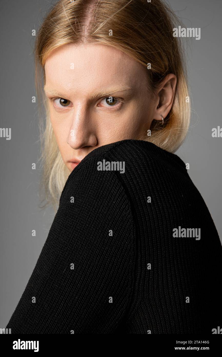 vertical shot of appealing non binary model in black turtleneck with ...