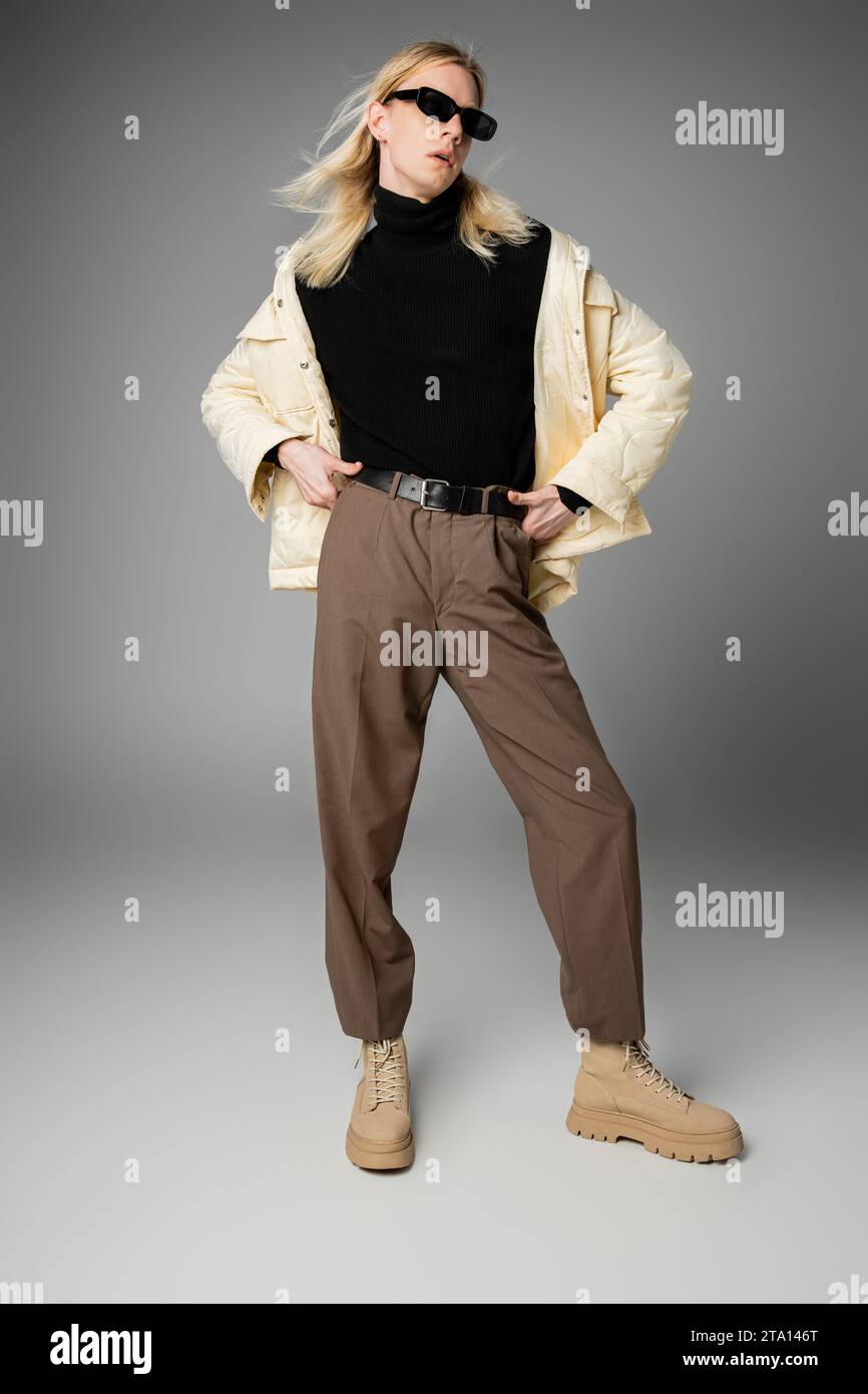 attractive non binary person in stylish winter outfit with sunglasses ...