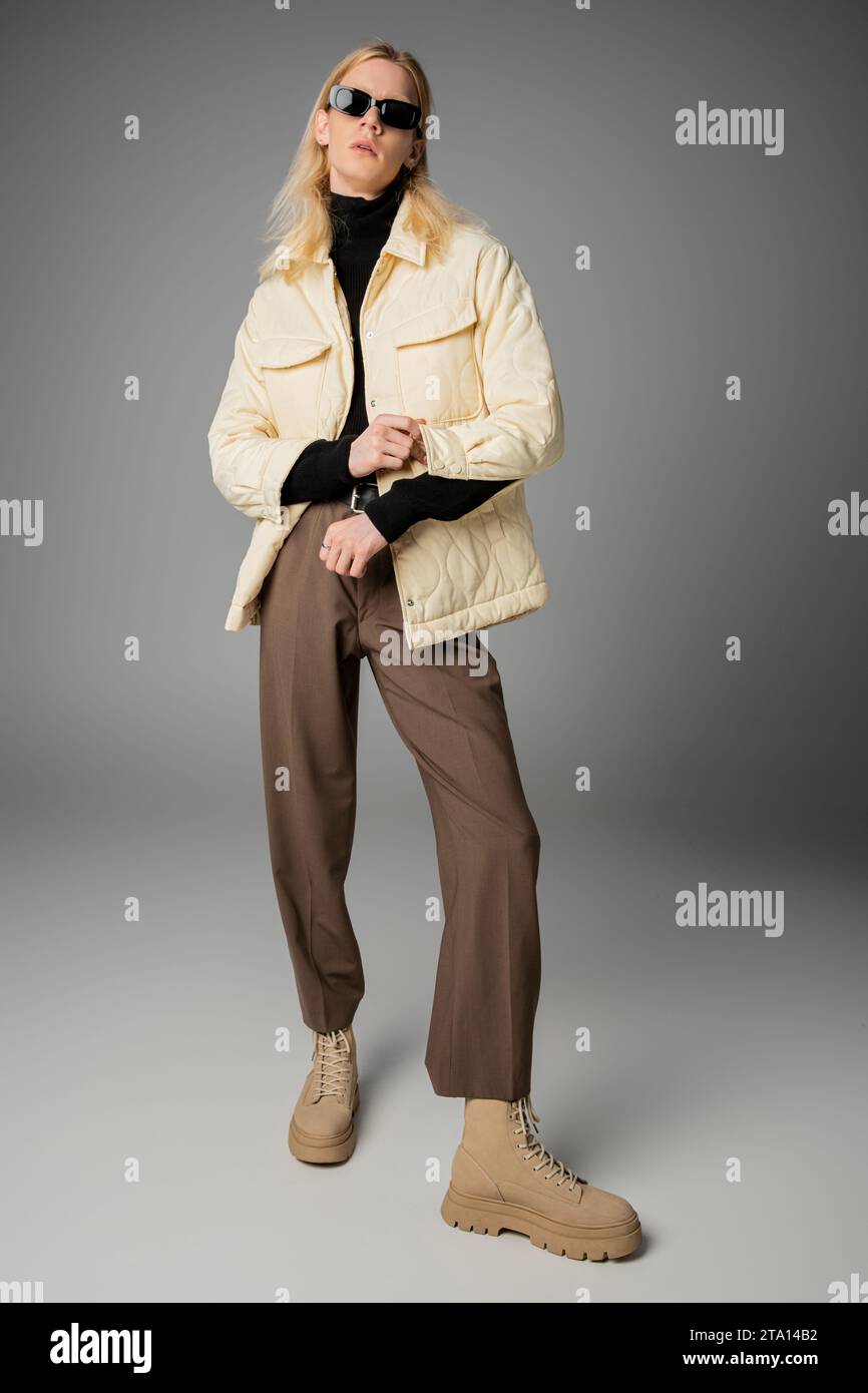 appealing non binary person in winter stylish outfit with sunglasses ...