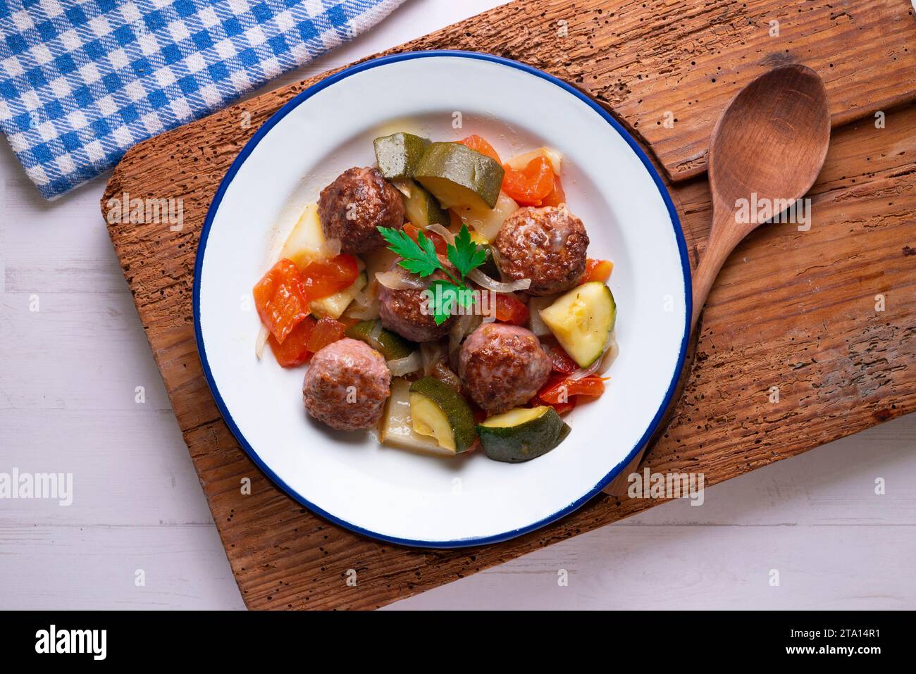 Meat meatballs with tomato sauce and vegetables. Traditional Spanish ...