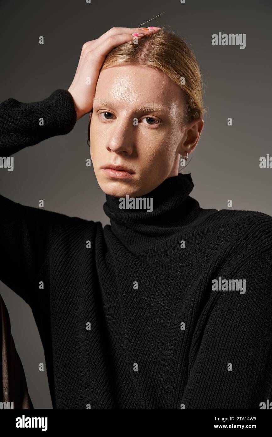 vertical shot of attractive non binary person with red hair and ...