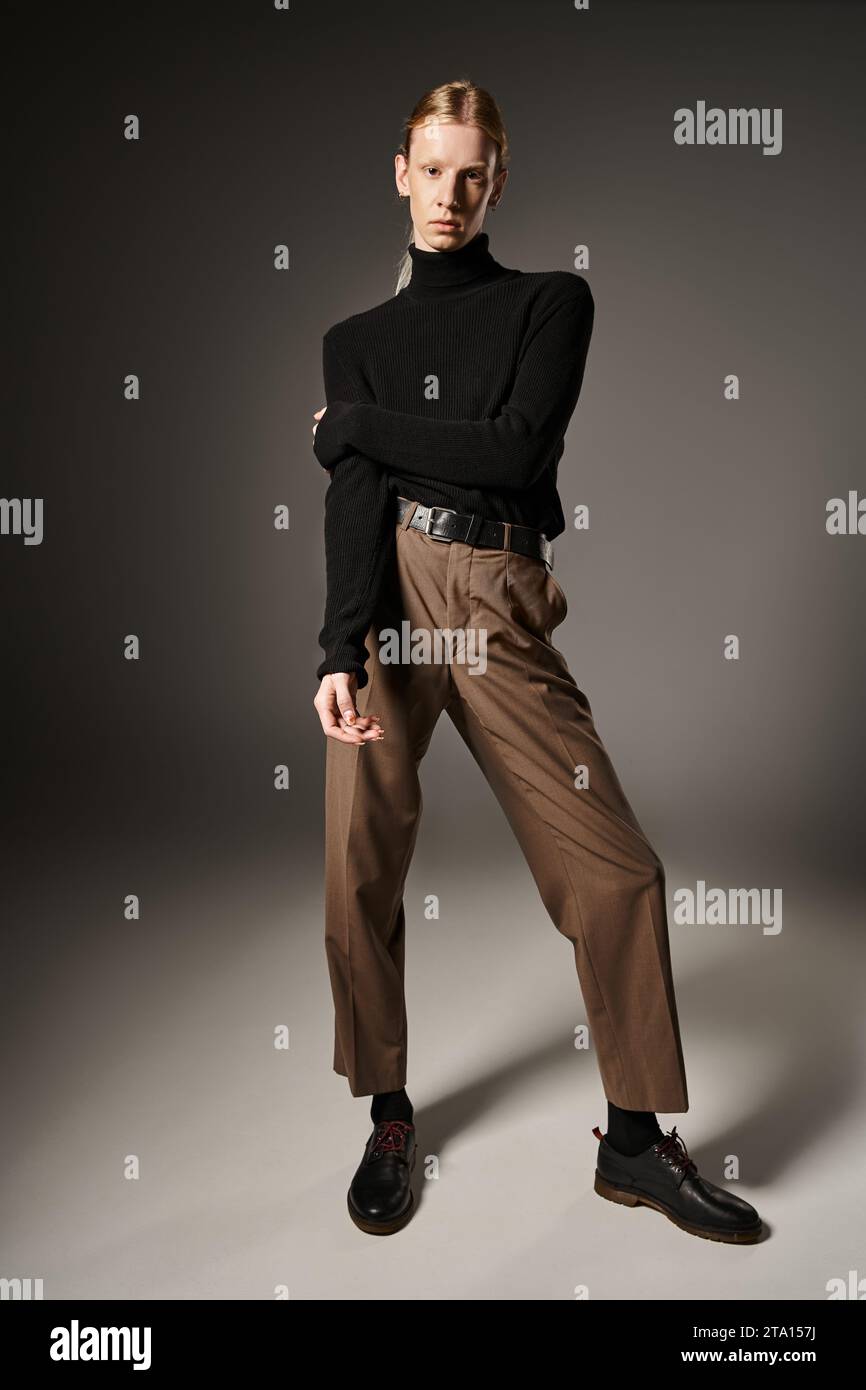 vertical shot of attractive young non binary model in black turtleneck ...