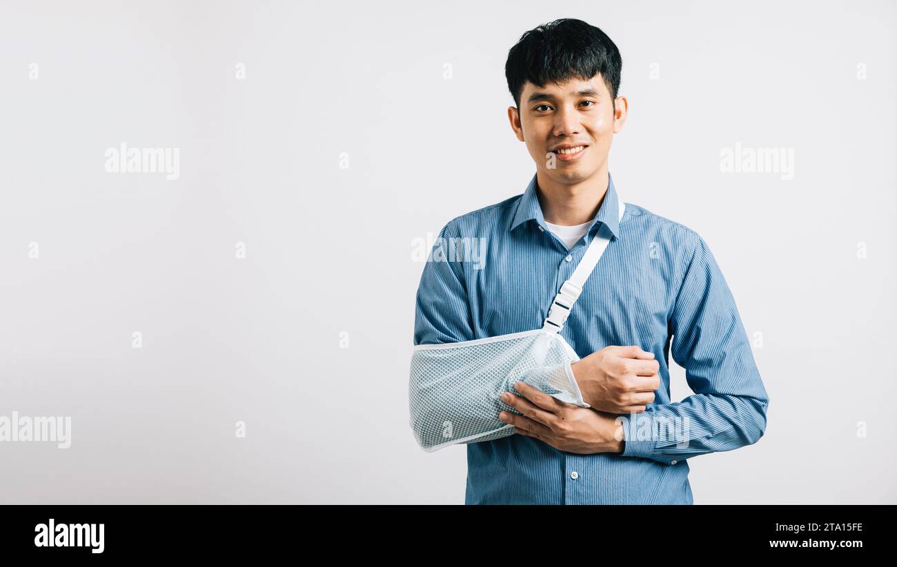 happy Asian man wears arm support in studio shot isolated Stock Photo ...