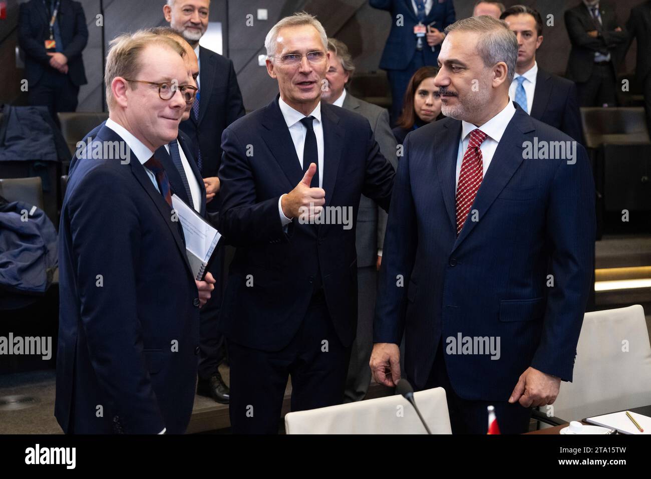 NATO Secretary General Jens Stoltenberg, center, speaks with Turkish Foreign Minister Hakan ...