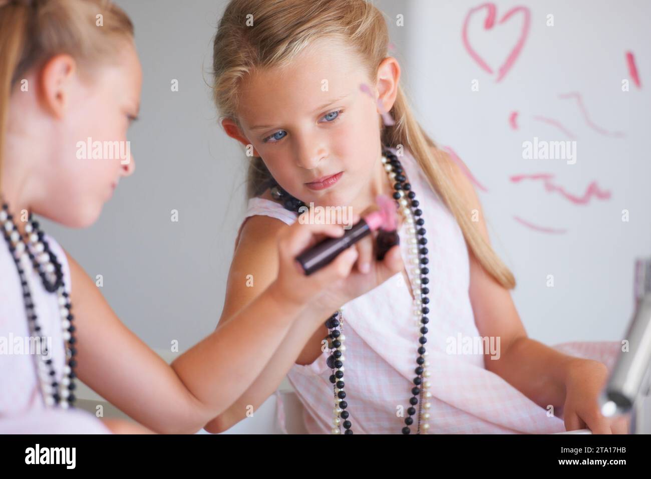 Little girl, lipstick and heart on mirror in bathroom for drawing, fun ...