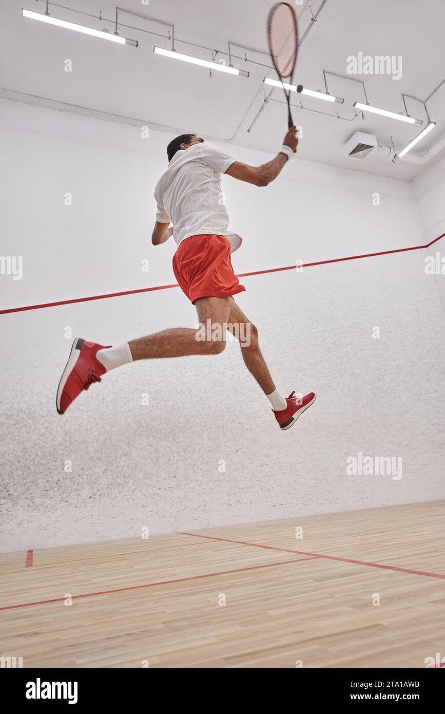 motion photo, active african american sportsman holding racquet while ...