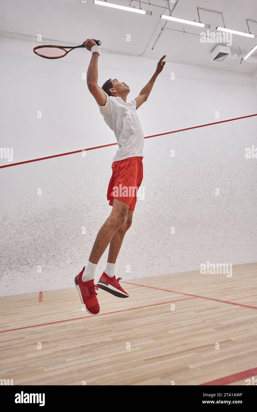 motion photo, energetic african american sportsman holding racquet ...