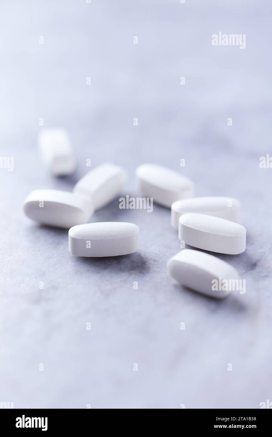 Beta - Alanine tablets. A dietary supplement on bright stone background ...