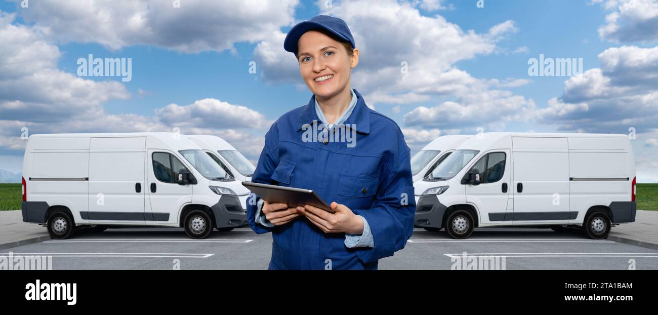 Female manager with a digital tablet on the background of vans. Fleet ...
