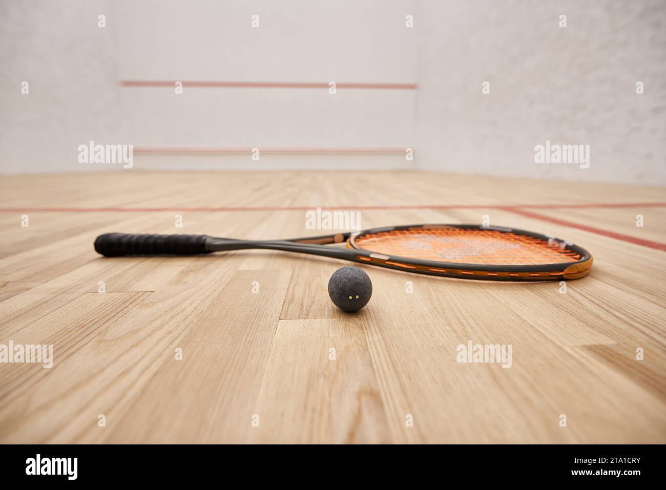 ball and racquet on floor inside of indoor squash court, motivation and ...