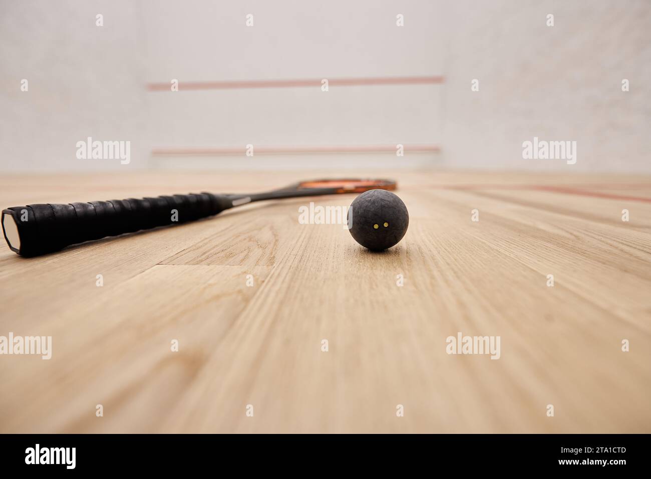 ball and racquet inside of squash court with white walls, motivation ...