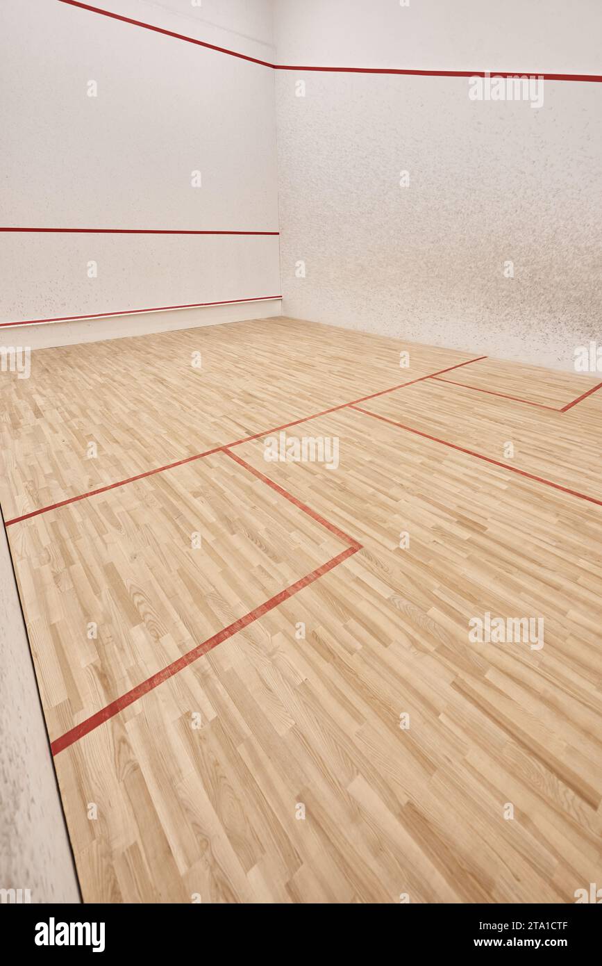 modern squash court room with white walls and polished floor ...