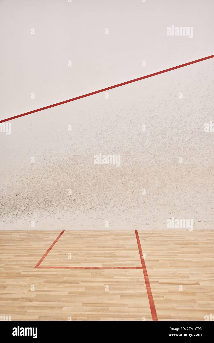 spacious and modern squash court with white walls and polished floor ...