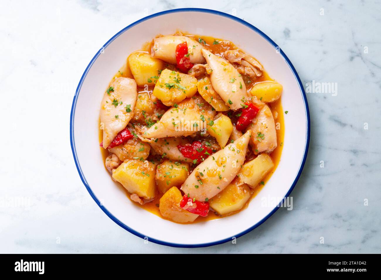 Squid stew with red peppers. Typical Spanish tapa recipe Stock Photo ...