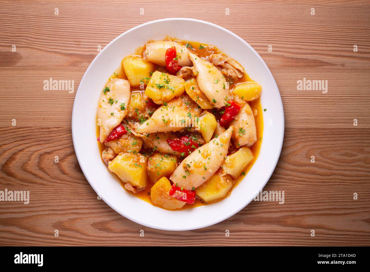 Squid stew with red peppers. Typical Spanish tapa recipe Stock Photo ...