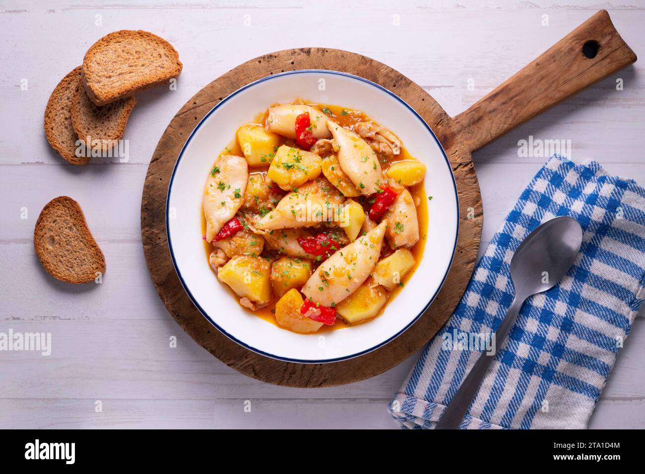 Squid stew with red peppers. Typical Spanish tapa recipe Stock Photo ...