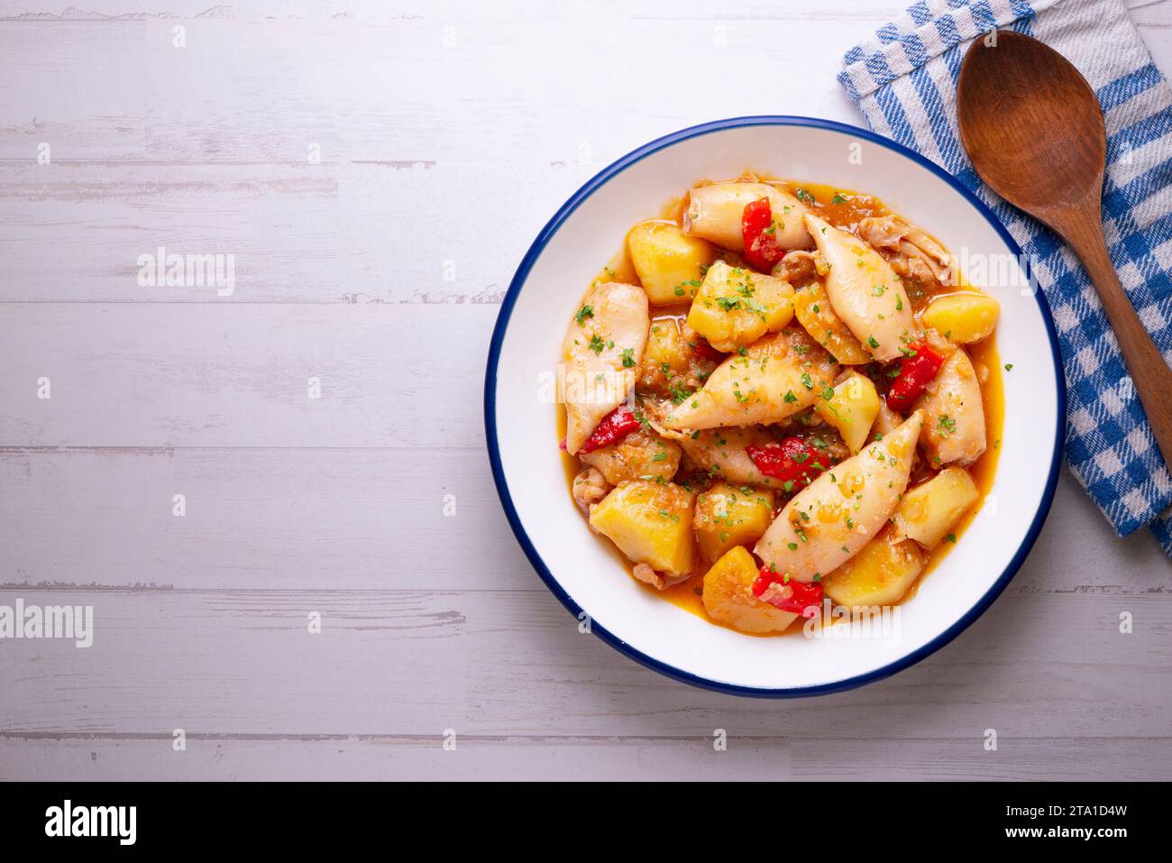Squid stew with red peppers. Typical Spanish tapa recipe Stock Photo ...