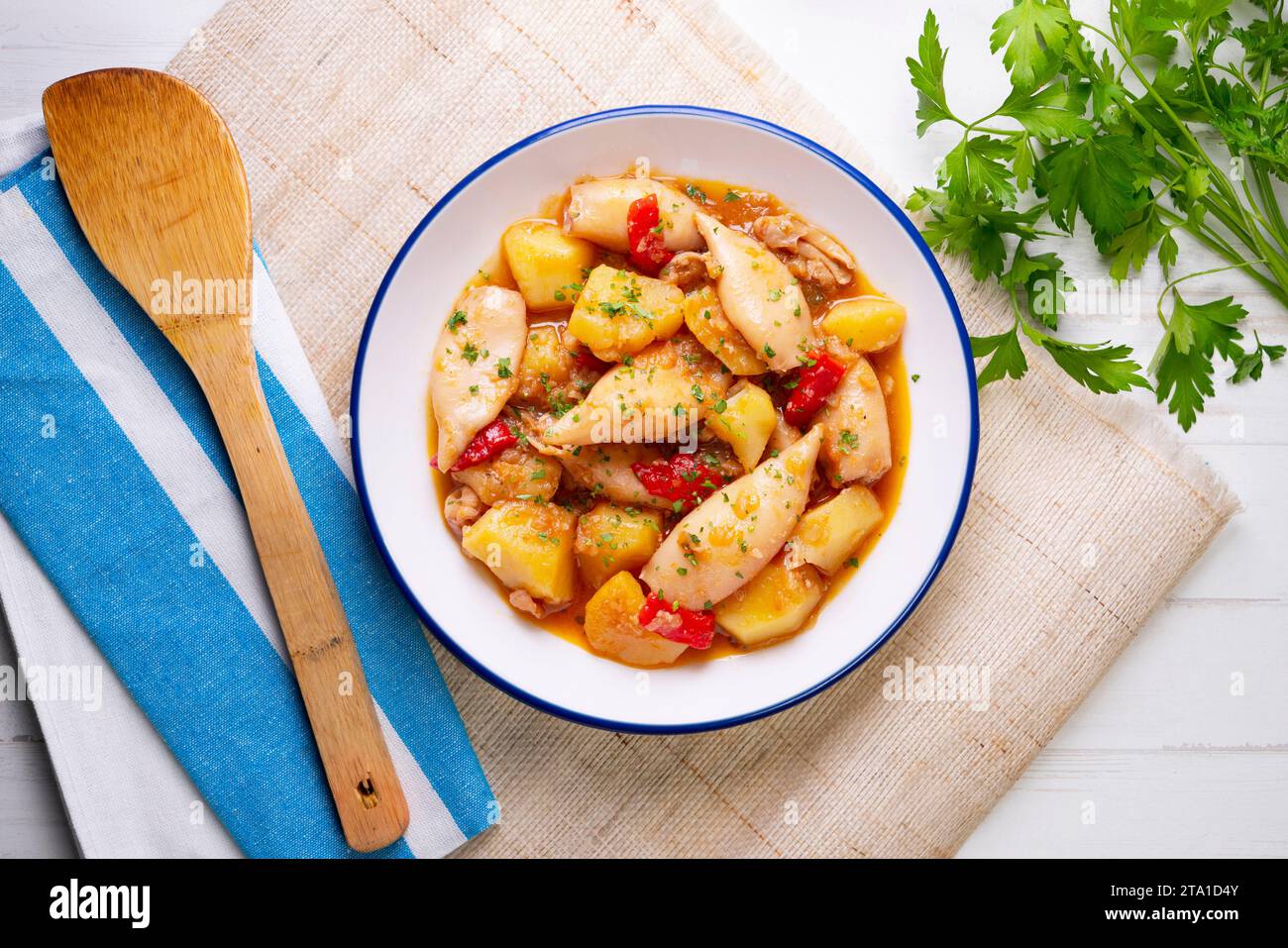 Squid stew with red peppers. Typical Spanish tapa recipe Stock Photo ...