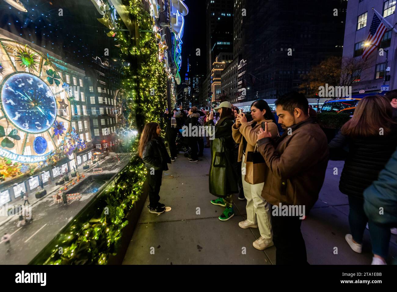 Thousands of visitors crowd Saks Fifth Avenue in New York to view their ...