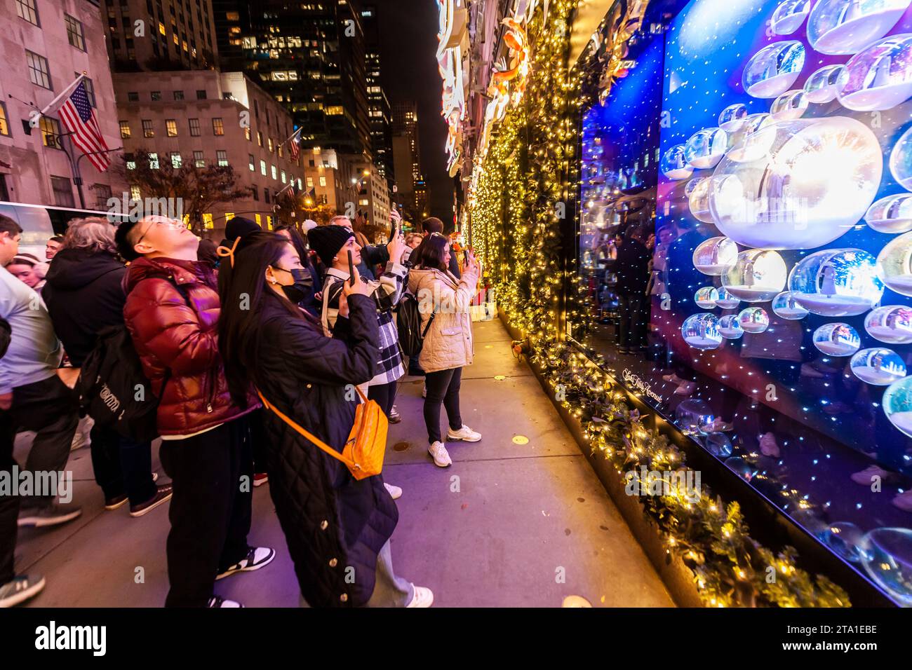 Thousands of visitors crowd Saks Fifth Avenue in New York to view their ...