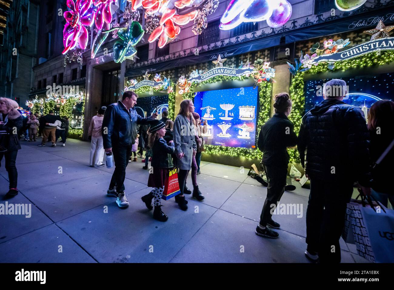 Thousands of visitors crowd Saks Fifth Avenue in New York to view their ...