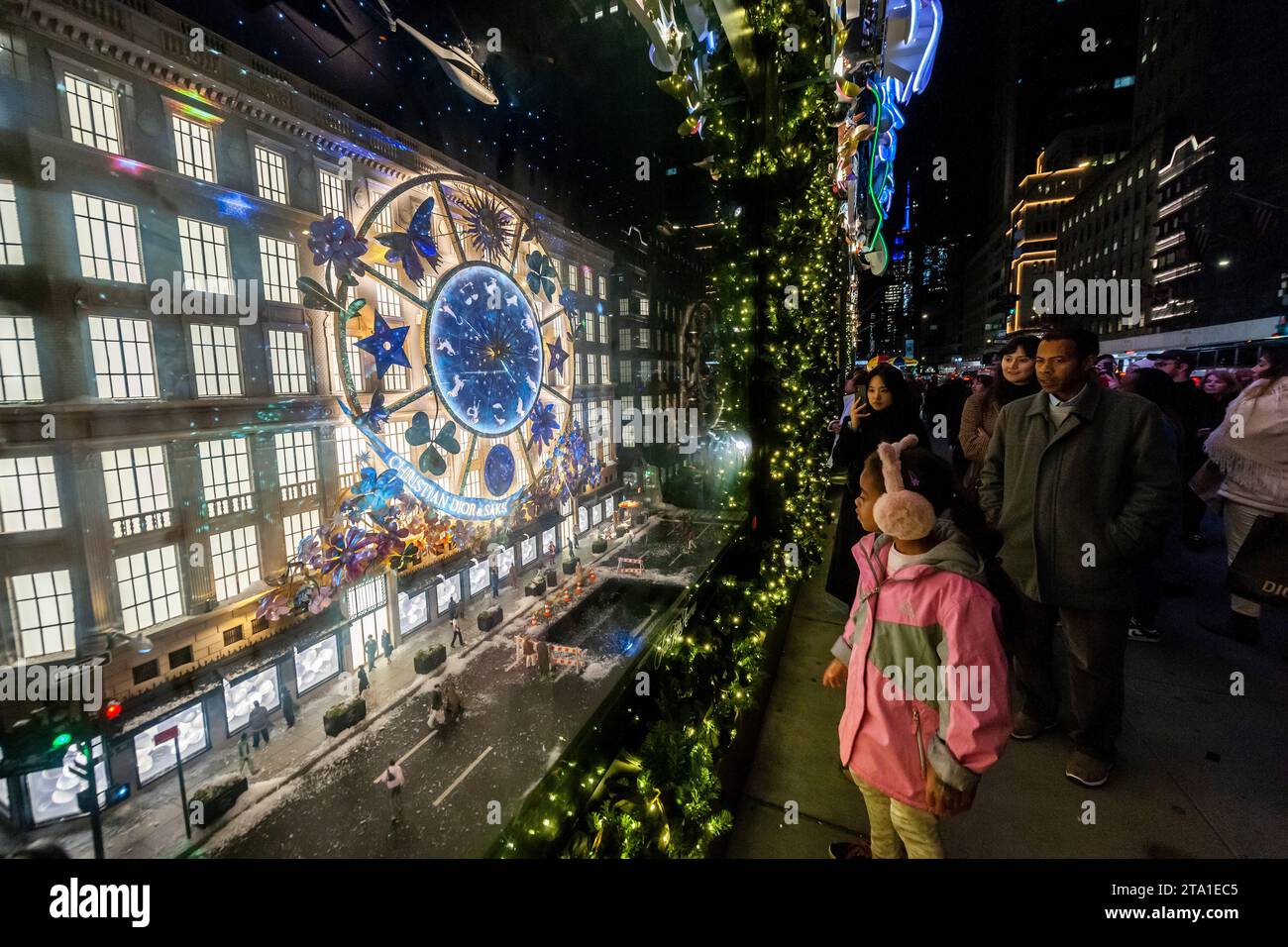 Thousands of visitors crowd Saks Fifth Avenue in New York to view their ...