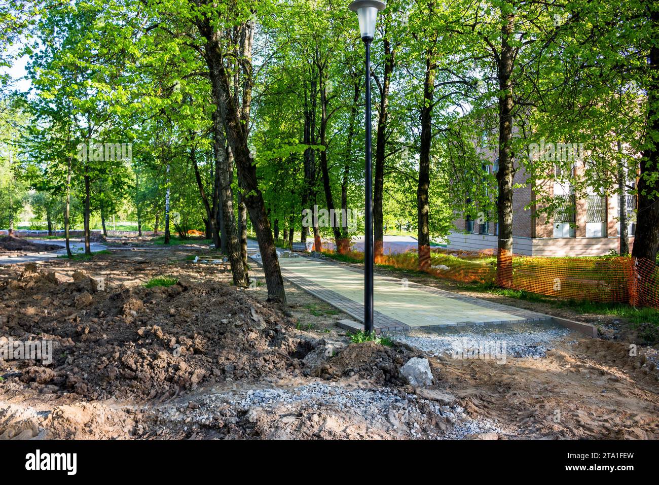 Laying paving slabs on a pedestrian path in a park Stock Photo - Alamy