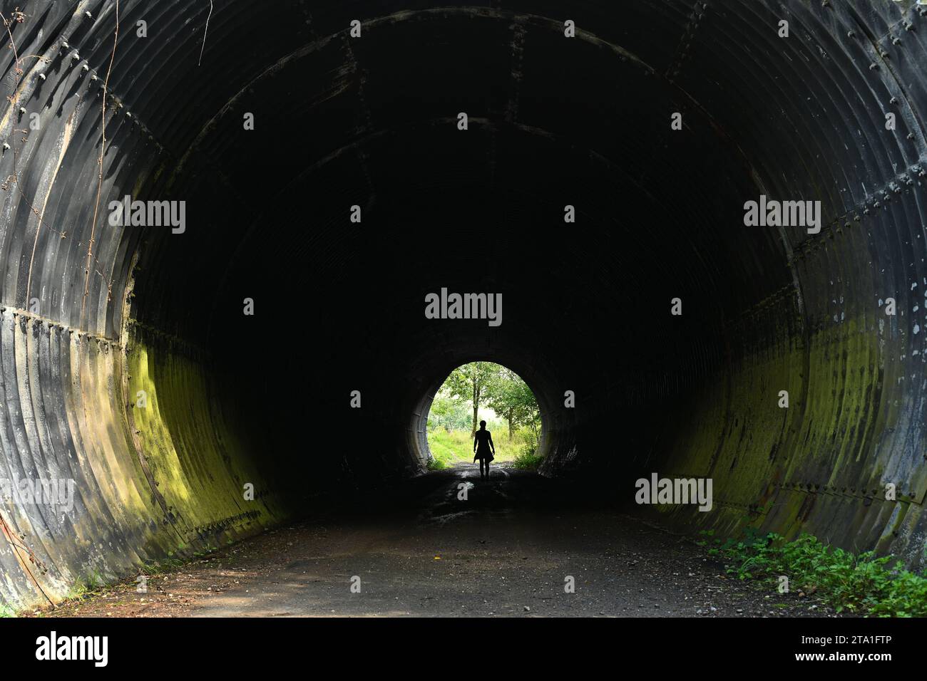 Tunnel woman walks through dark hi-res stock photography and images - Alamy