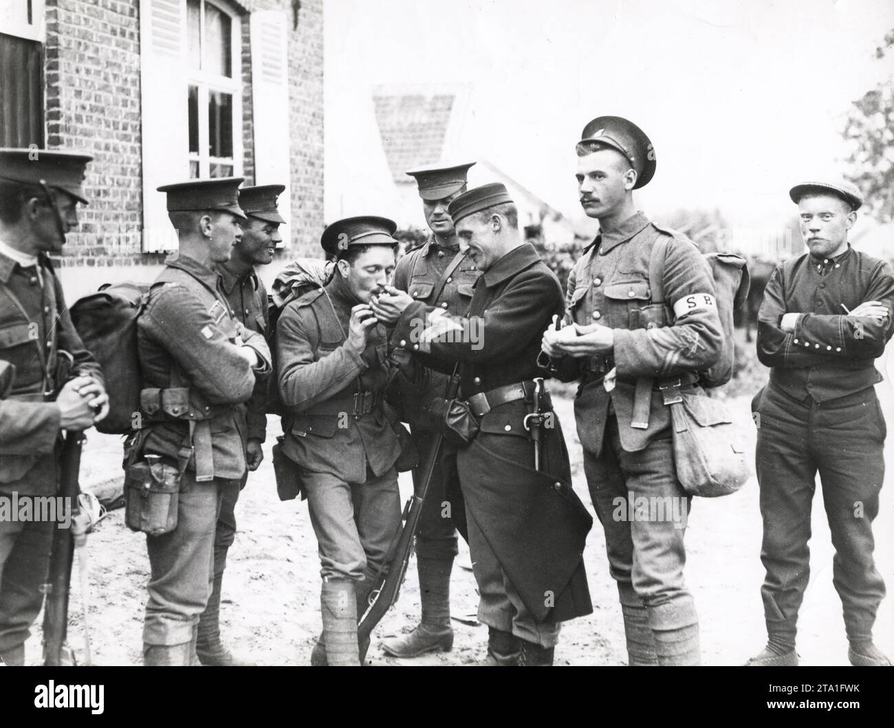 WW1 World War I - A Belgian soldier is given a light for his cigarette ...