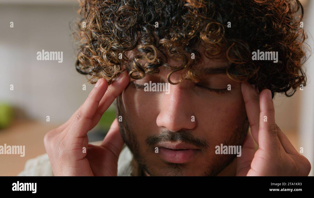 Close up ill Indian man massaging head pain ache blood pressure ...