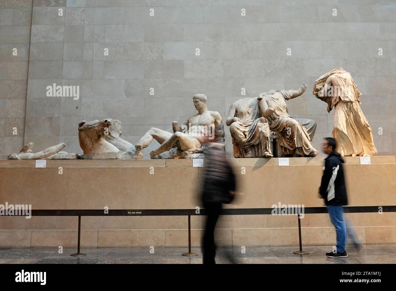 Visitors walk past sculptures that are part of the Parthenon Marbles at the British Museum in ...
