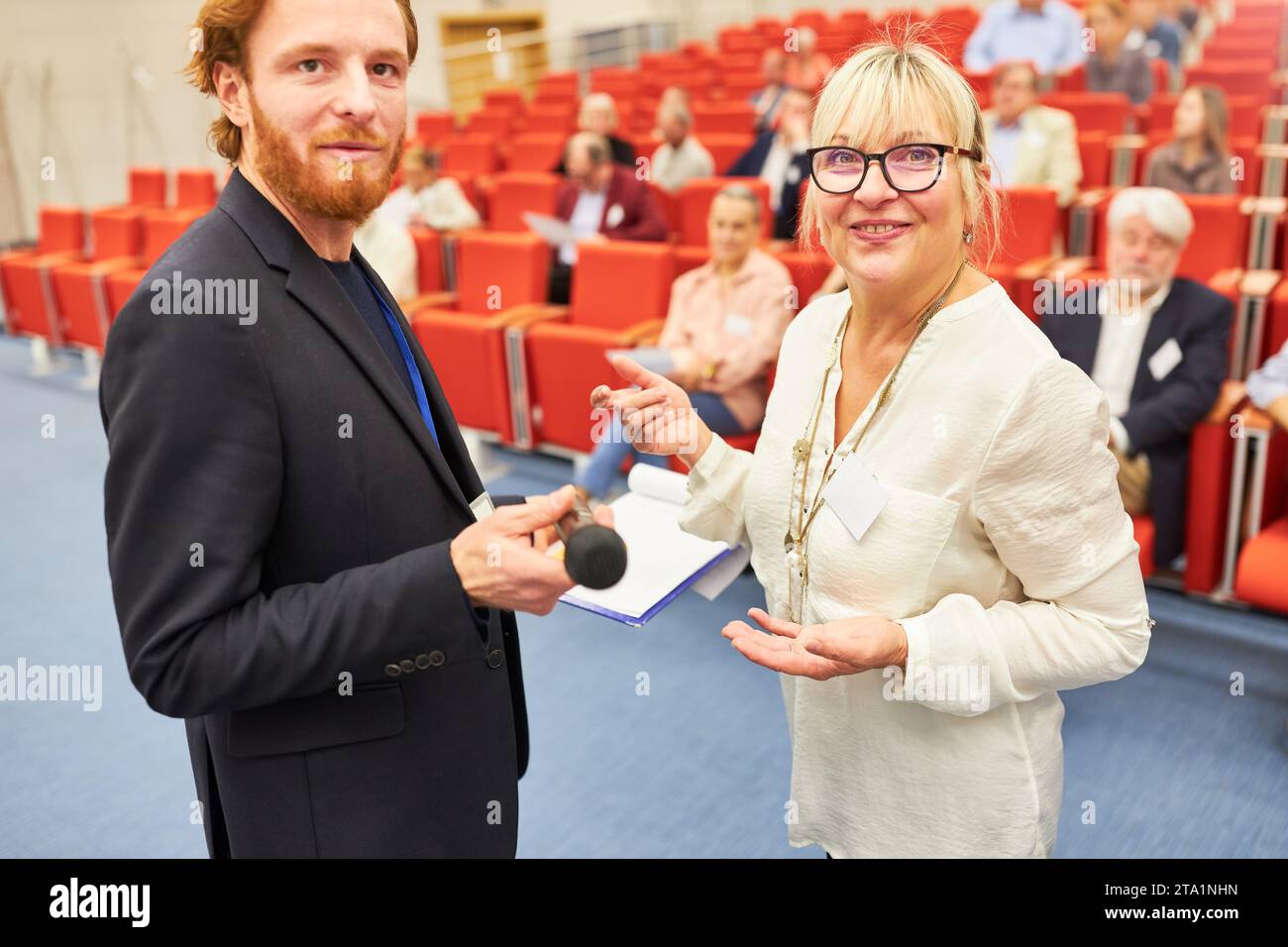 Professional speaker engaging with audience during interactive seminar ... Professional speaker engaging with audience during interactive seminar ...