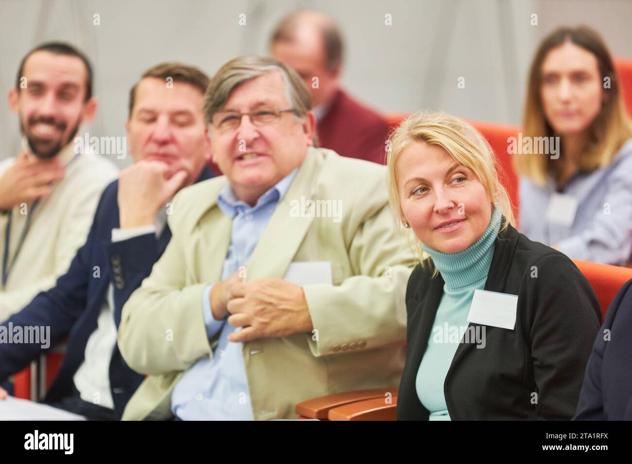Male and female audience sitting in business conference at convention ...
