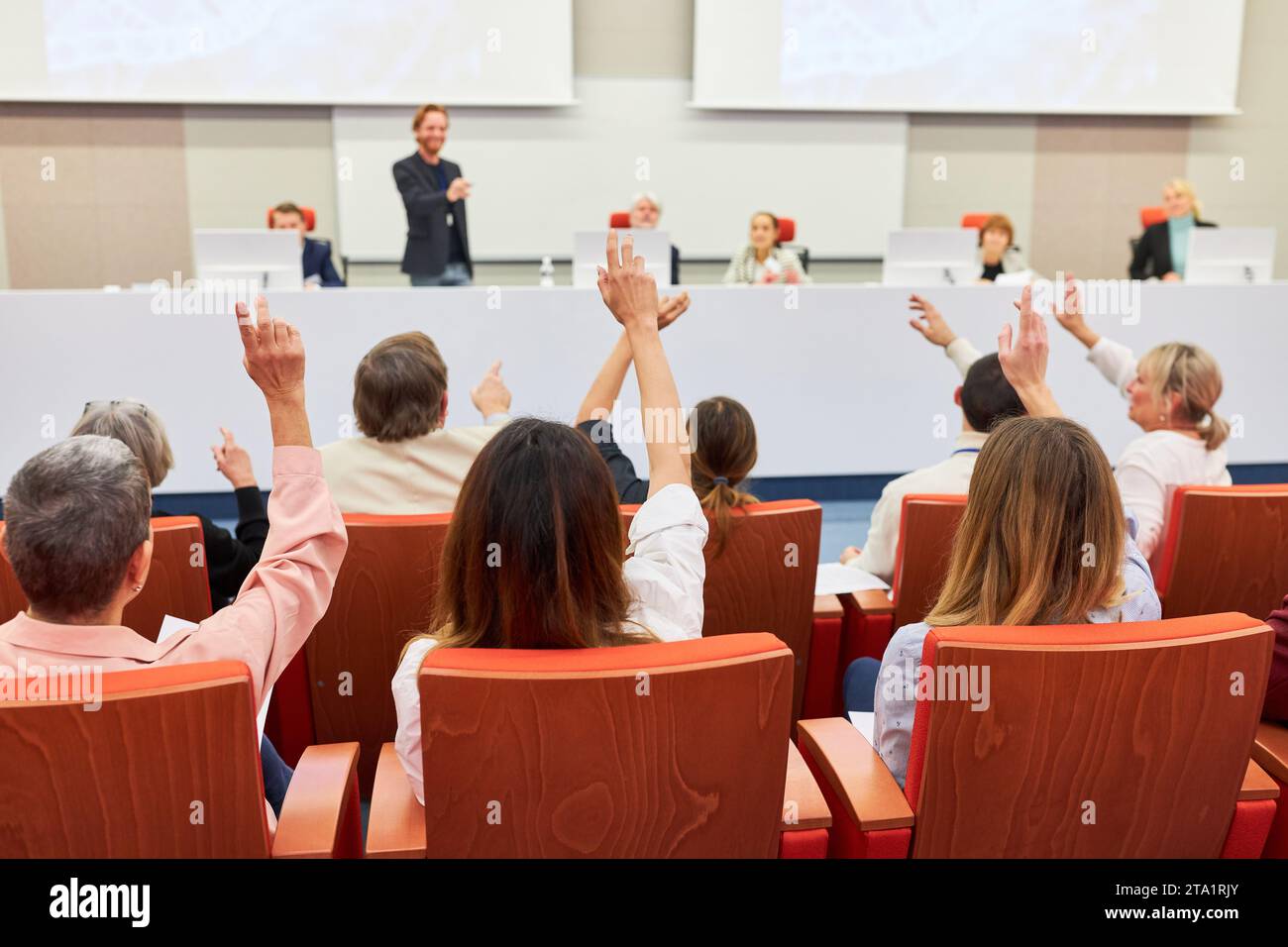 Professionals sitting in audience asking questions to orator during ...