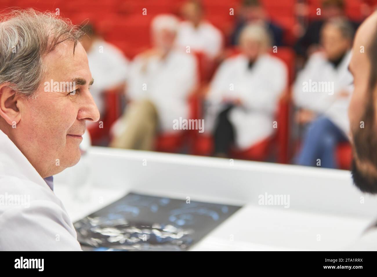 Speakers discussing on stage in front of audience during medical ...