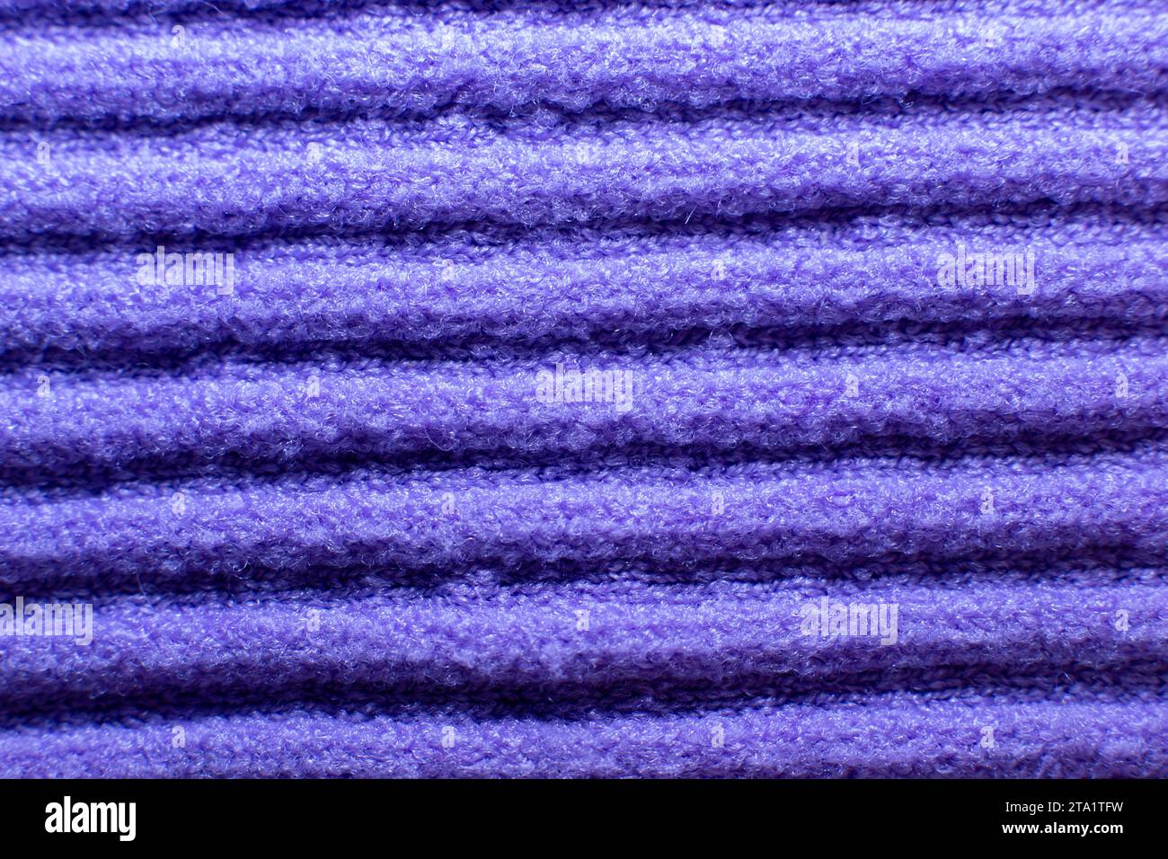 Texture of the violet fabric of a garment. Pattern in horizontal ...