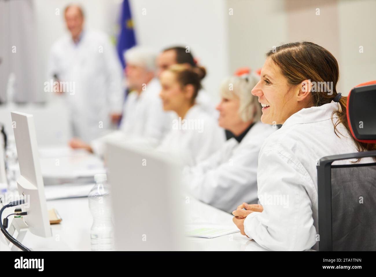 Speaker panel with male and female doctors on stage at medical health ...