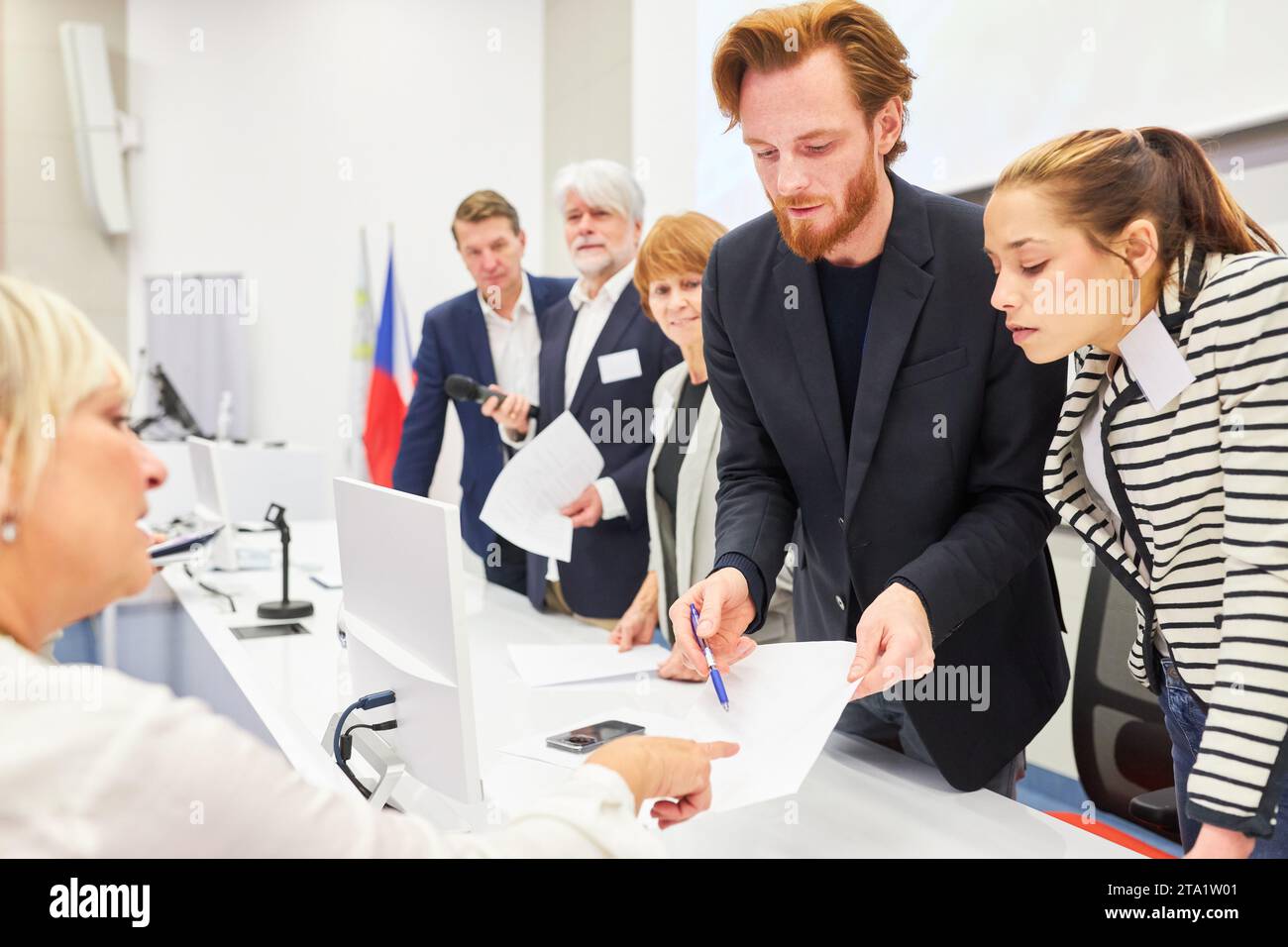 Speakers explaining audience over document at table during conference ...