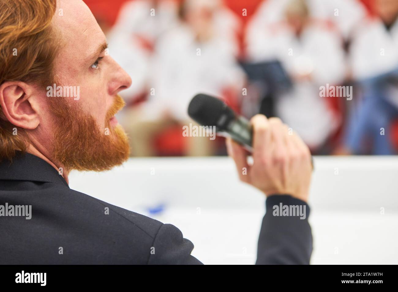 Male speaker giving speech through microphone at medical seminar in ...