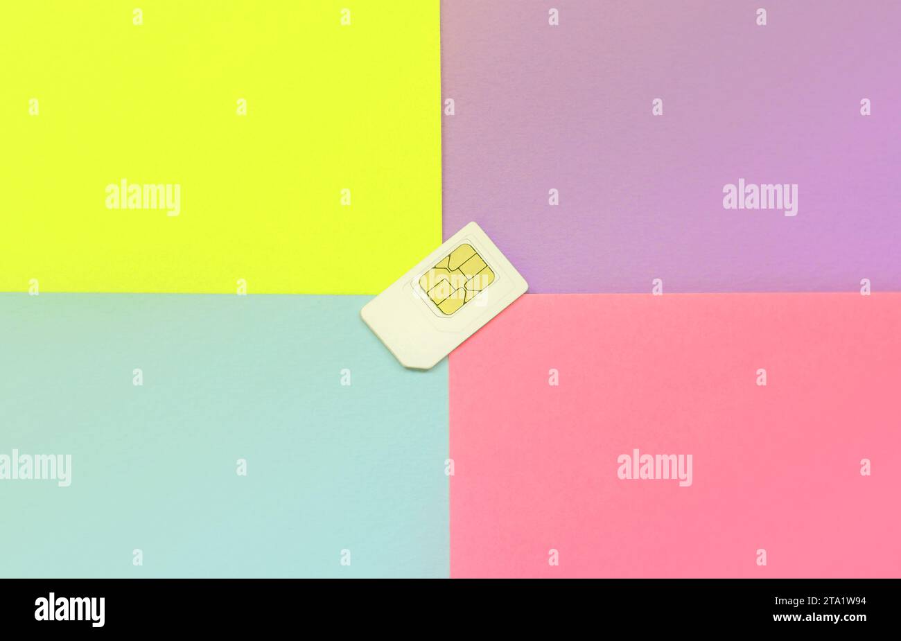 Subscriber identity module. New white SIM card on bright multicolor ...