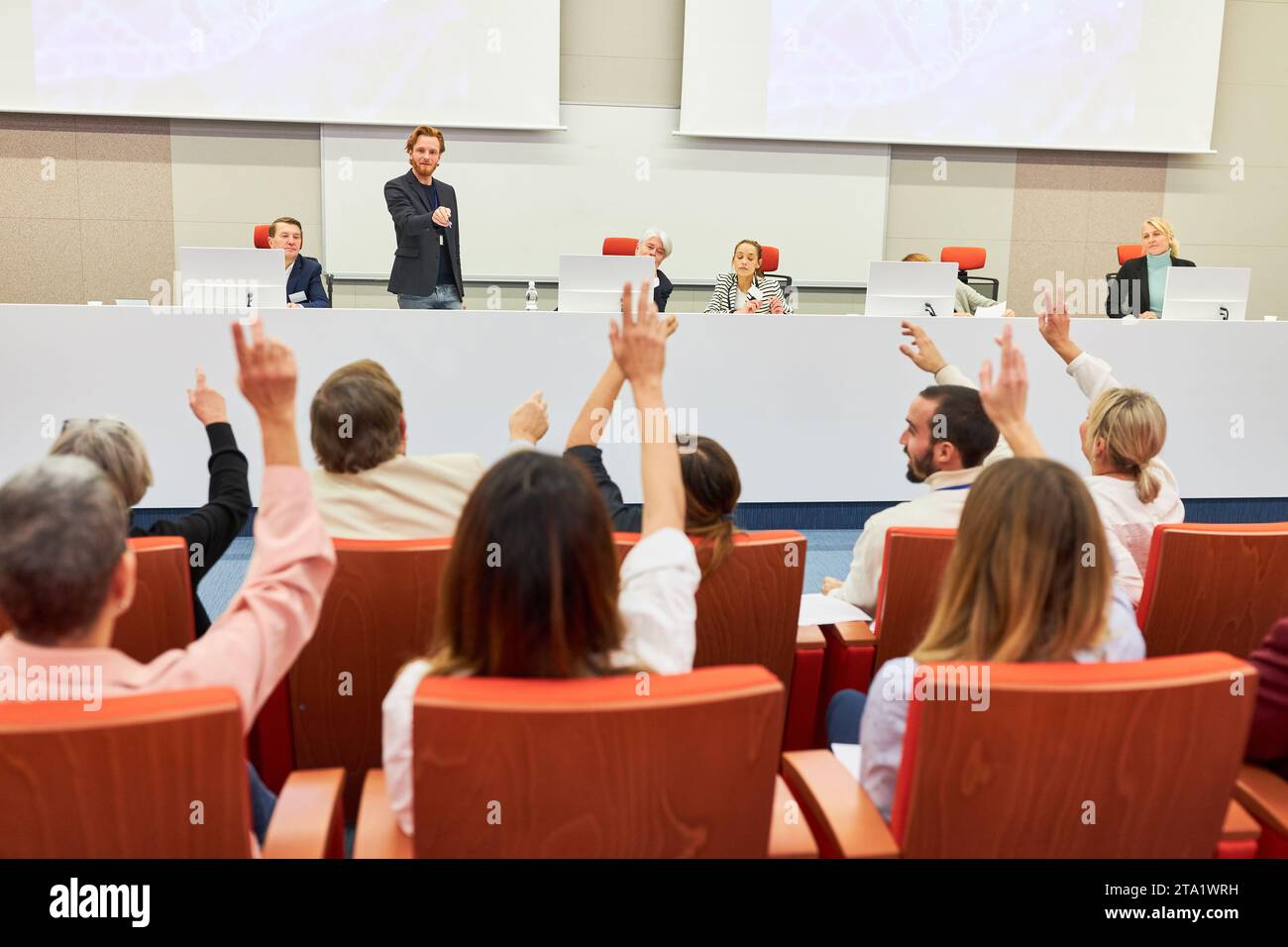 Audience asking questions to orator during business conference in ...